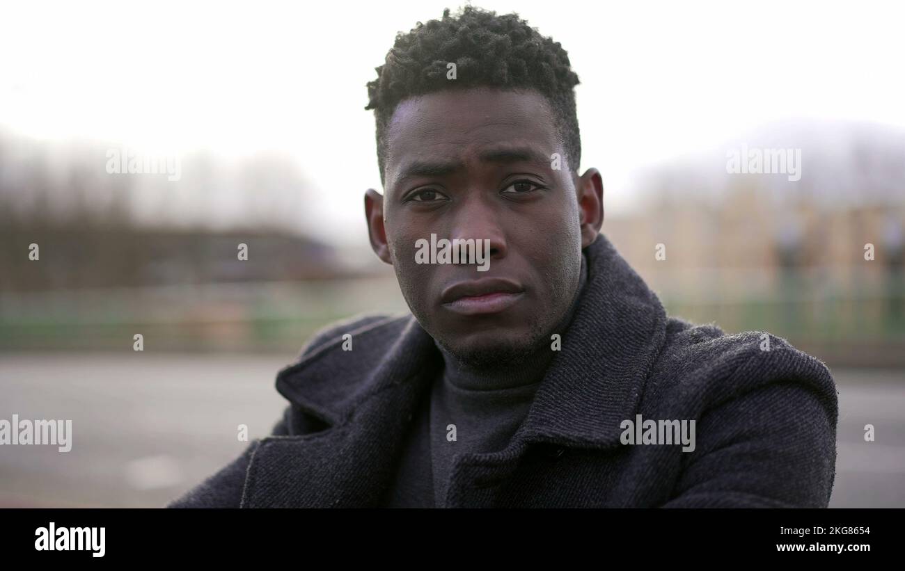 Portrait young black African man serious face expression looking at ...