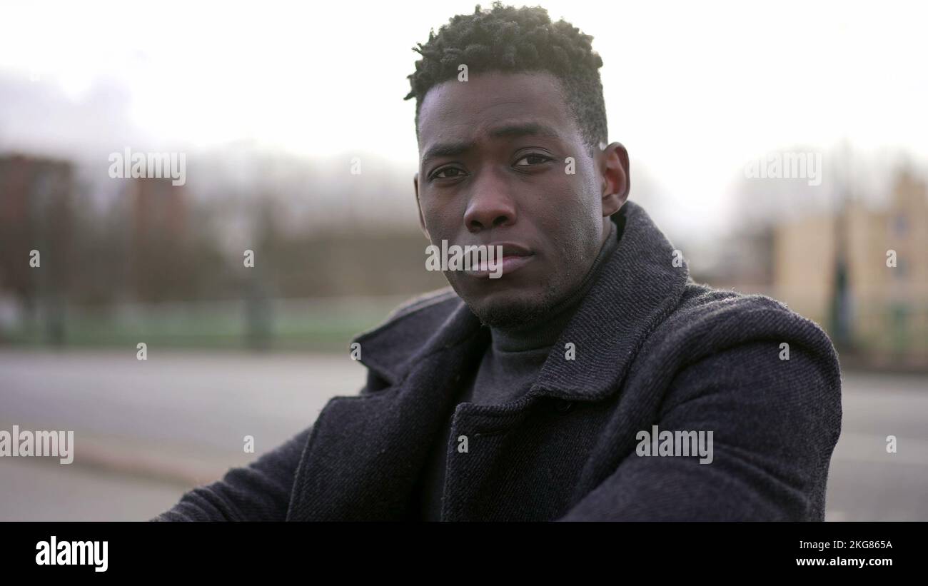 Portrait young black African man serious face expression looking at ...