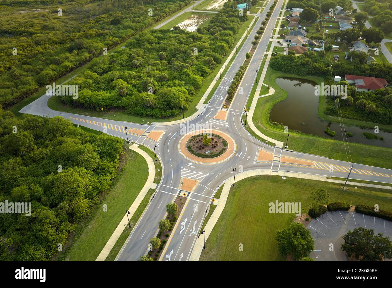 Aerial view of road roundabout intersection with moving cars traffic ...