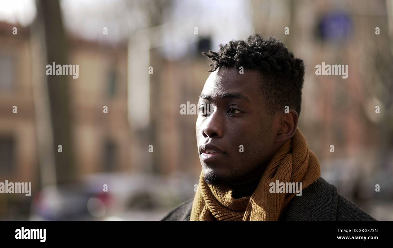 Happy thoughtful african man walking hi-res stock photography and ...