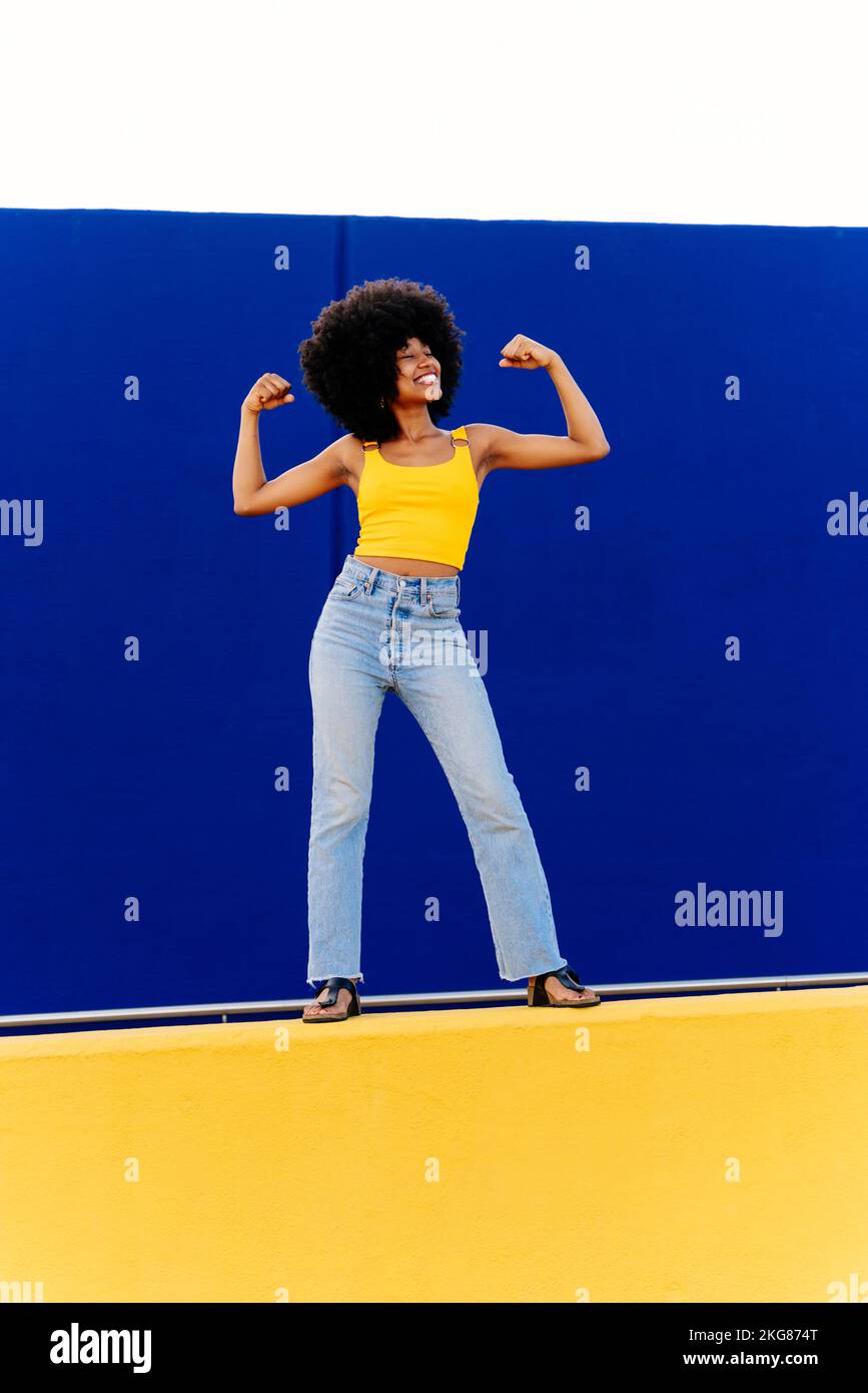 Beautiful Young Happy African Woman With Afro Curly Hairstyle Strolling