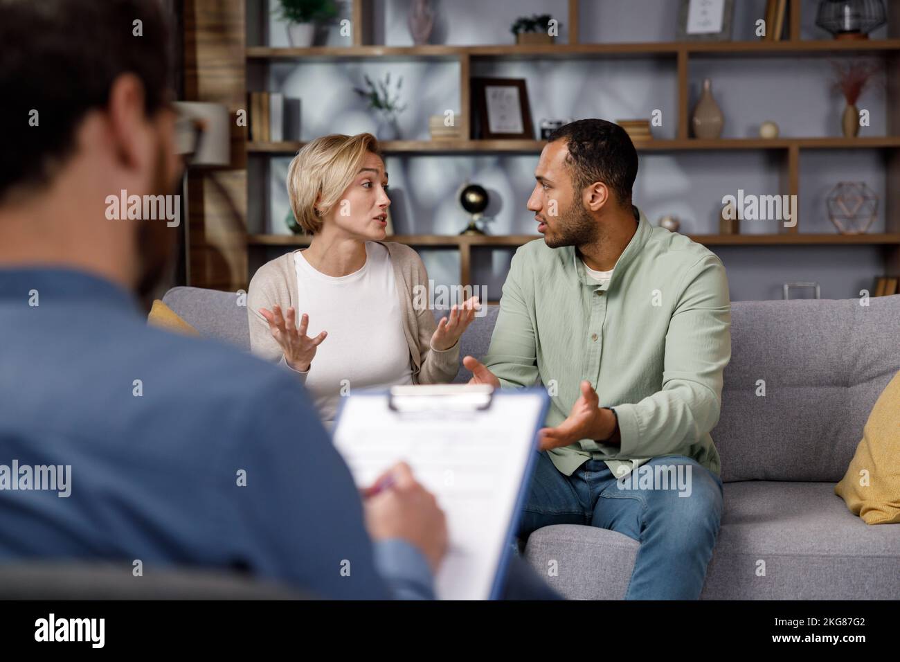 Multiracial quarrel between husband and wife at a session with a ...