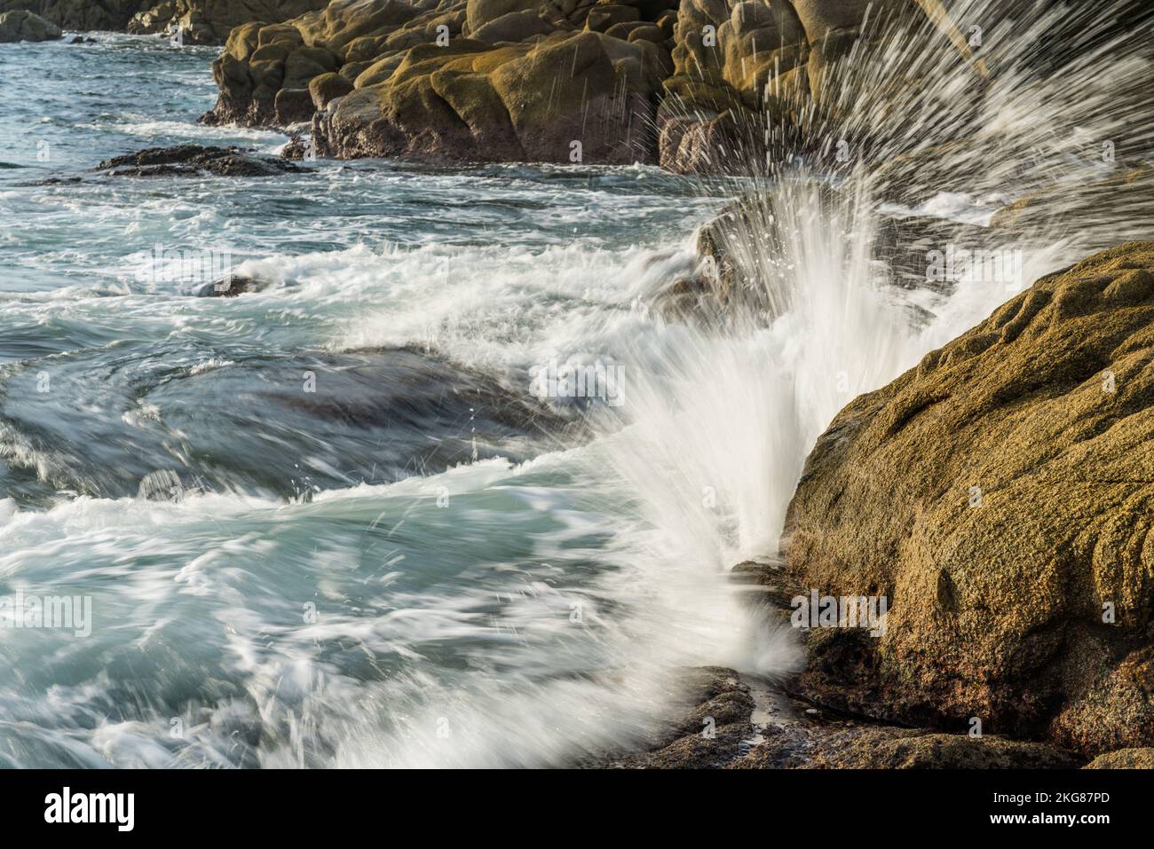 Waves crashing on the rocks on Chahue Beach in the Bahias of Huatulco ...