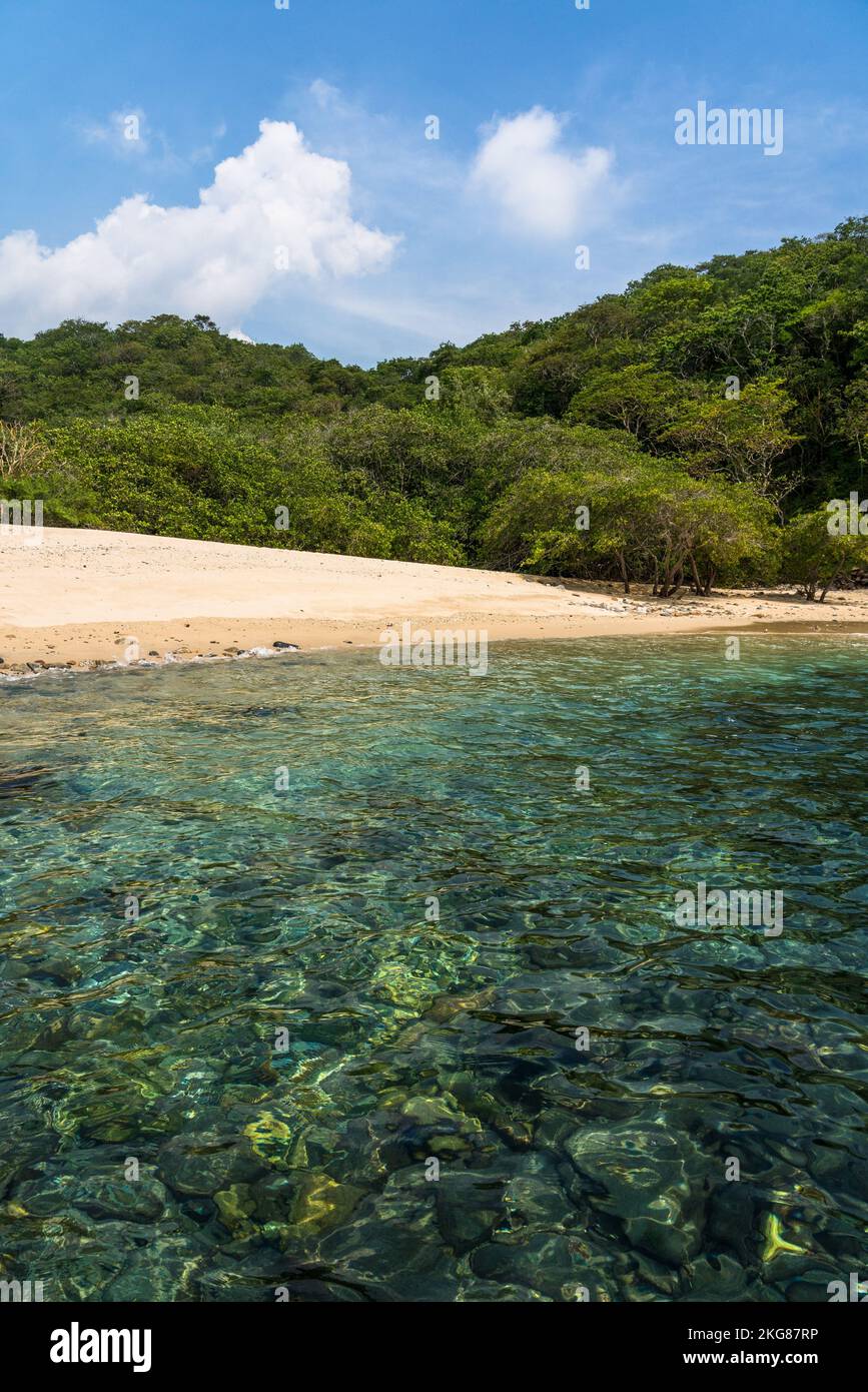A small, secluded beach with crystal-clear water that can only be ...