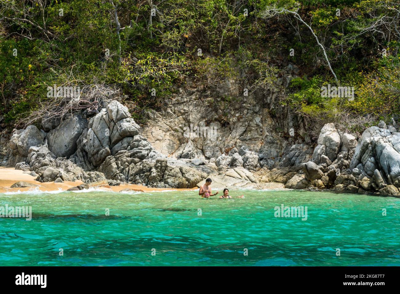 Tourists swimming at Playa Organo or Pipe Organ Beach in Huatulco ...