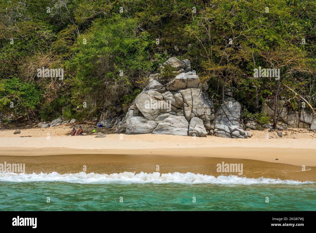 Tourists relaxing on secluded Playa Organo or Pipe Organ Beach in ...