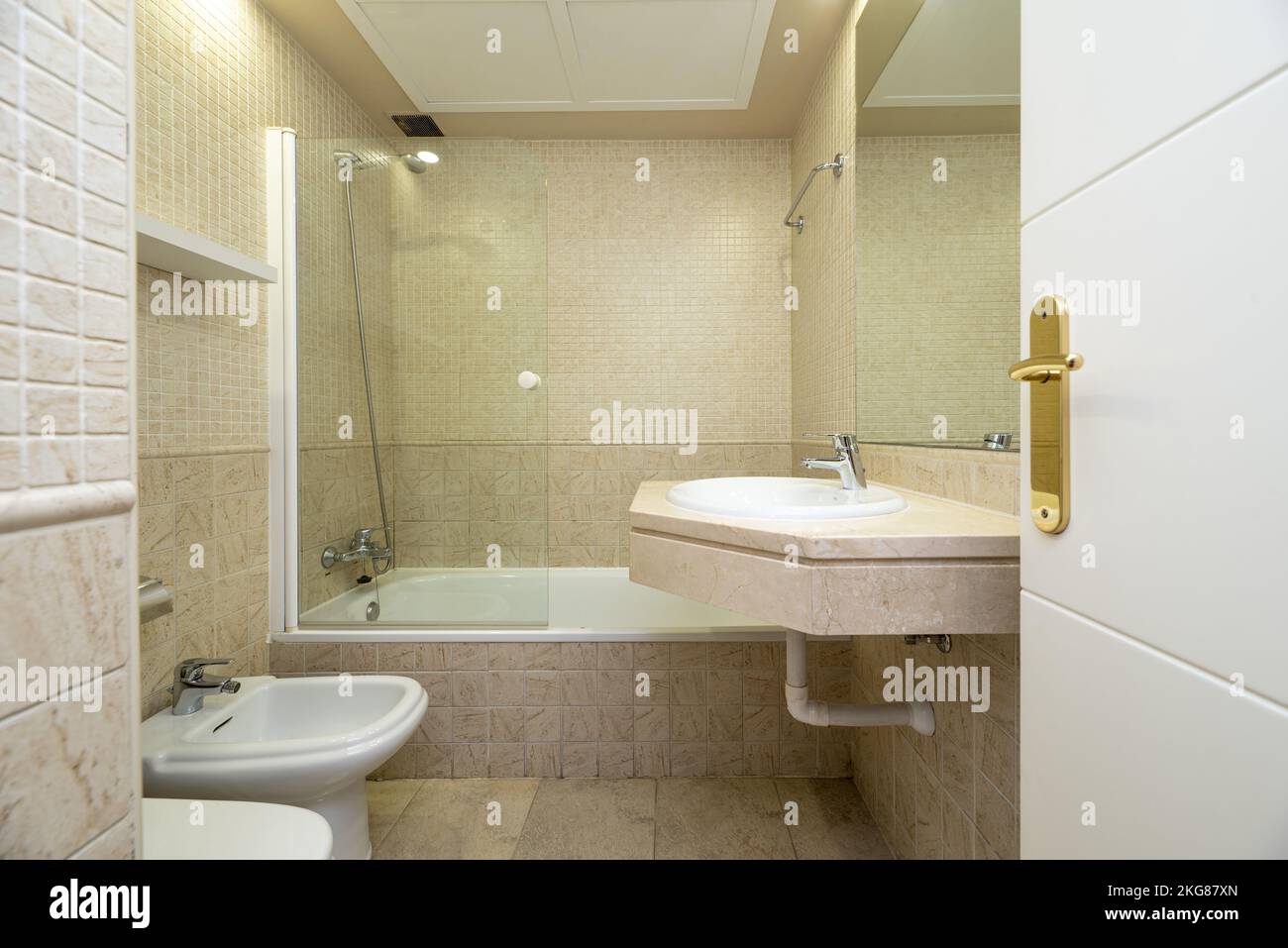 Bathroom with large mirrors on the walls covered in imitation marble ...