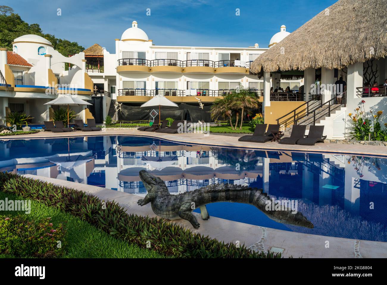 A crocodile sculpture by the pool at a resort hotel on Chahue Beach in ...