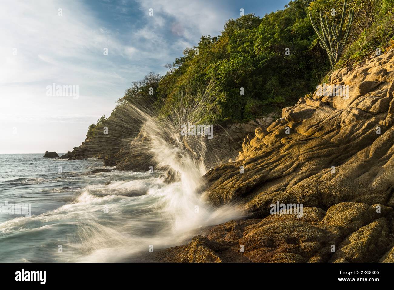 Waves crashing on the rocks on Chahue Beach in the Bahias of Huatulco ...