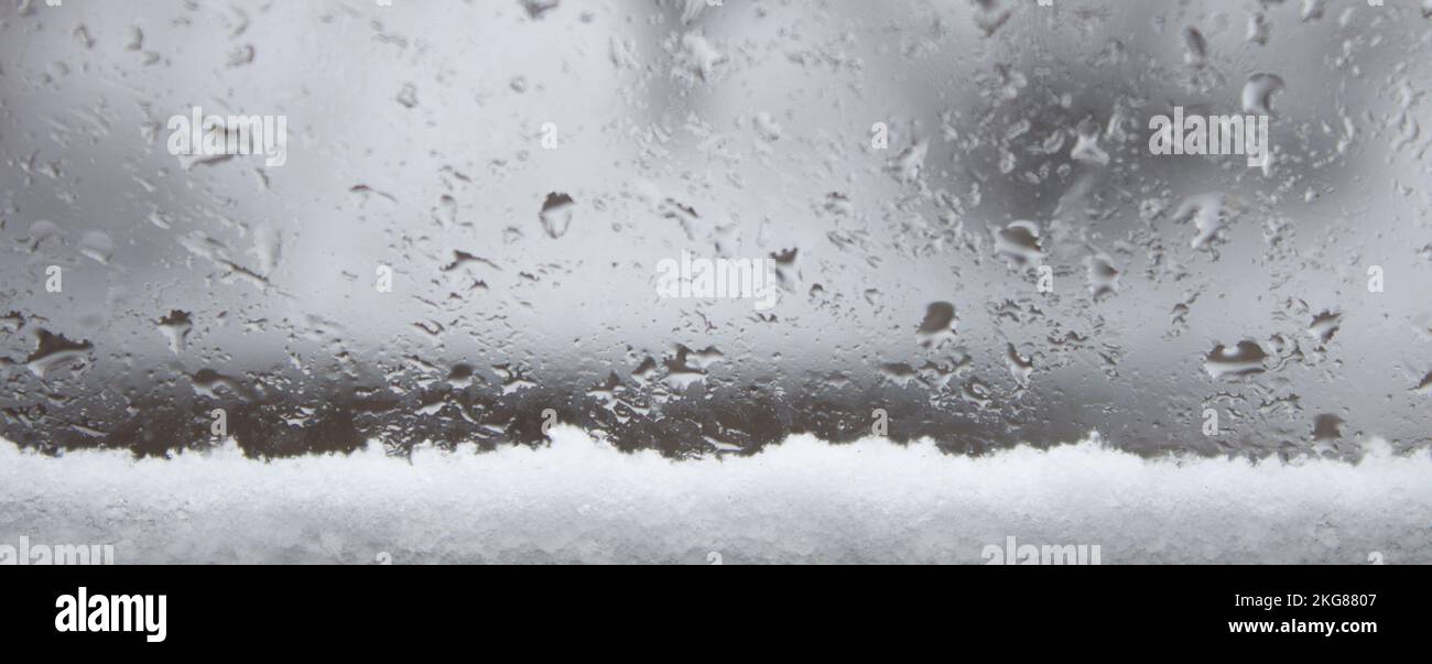 Raindrops on a blurred window and snow nearby, space for text Stock ...
