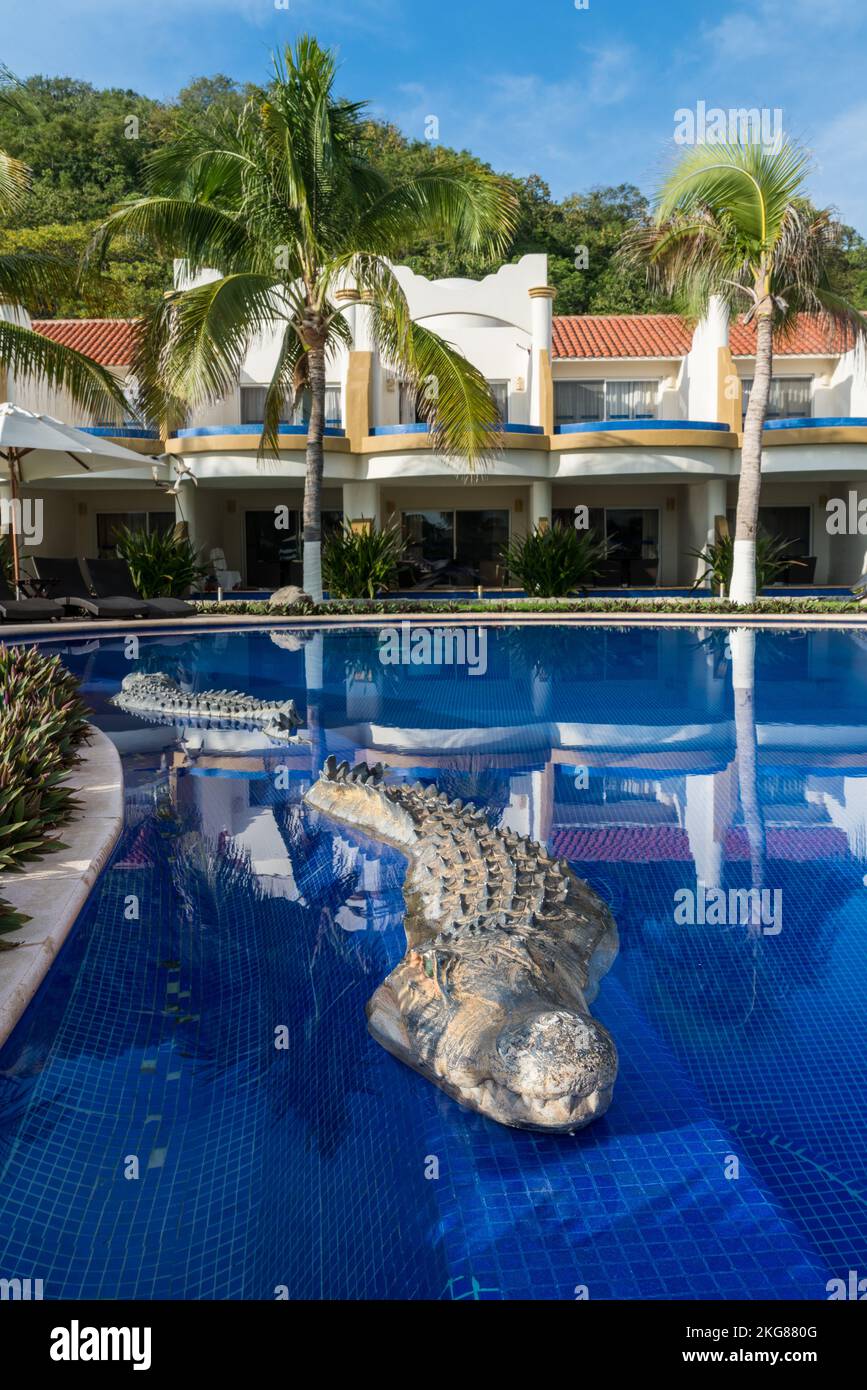 A crocodile sculpture by the pool at a resort hotel on Chahue Beach in ...