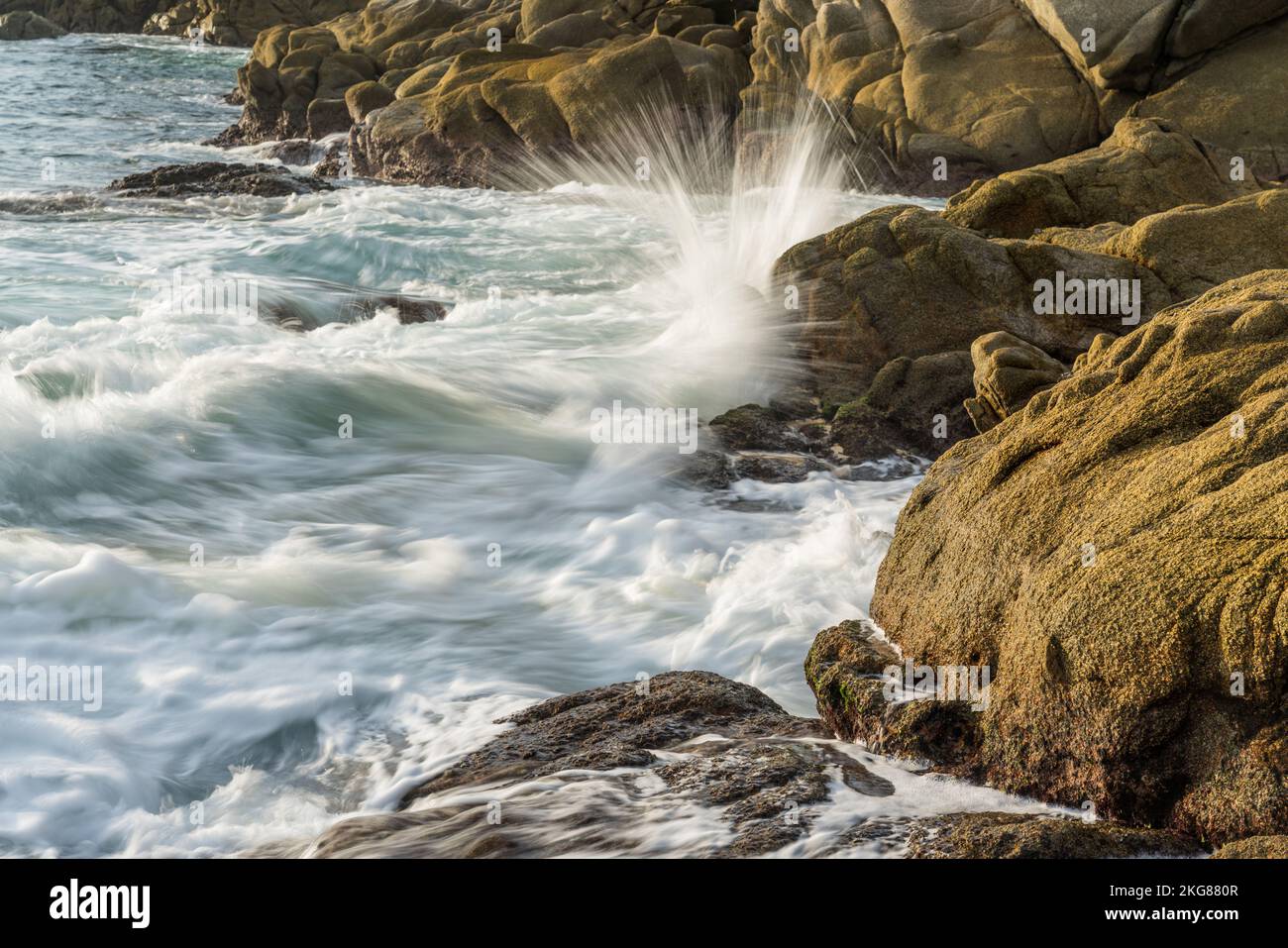 Waves crashing on the rocks on Chahue Beach in the Bahias of Huatulco ...