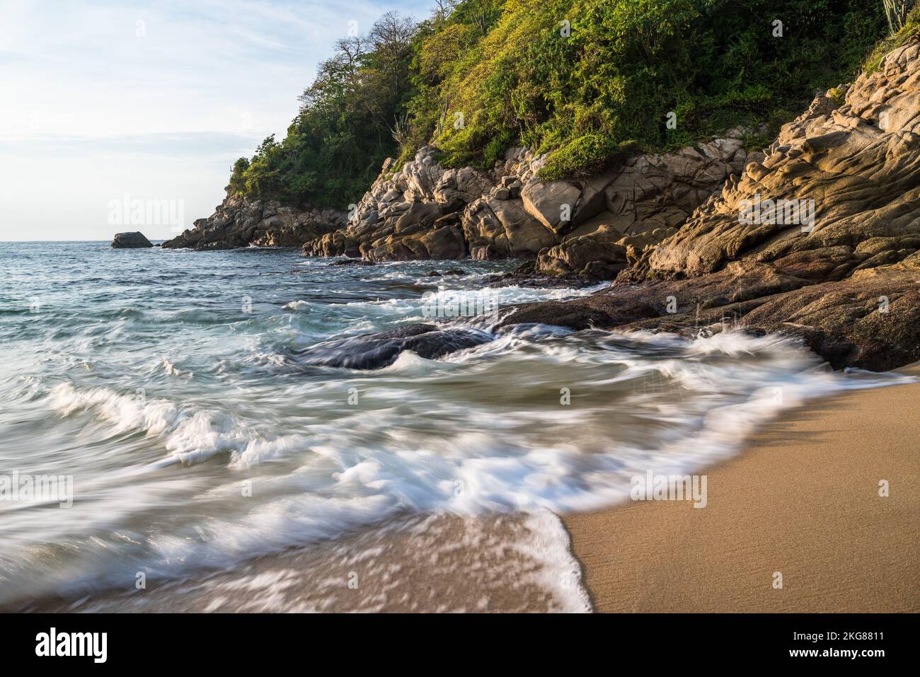 Waves crashing on the rocks on Chahue Beach in the Bahias of Huatulco ...