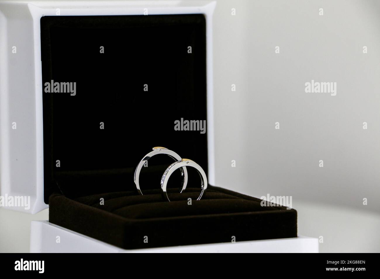 A couple of pristine and exquisite his and hers shiny wedding rings ...