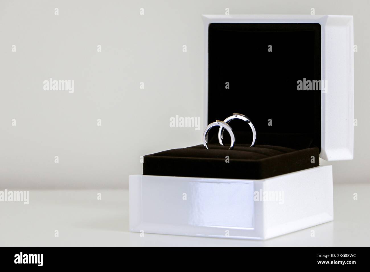 A couple of beautiful shiny wedding rings sparkling in open ring box on ...