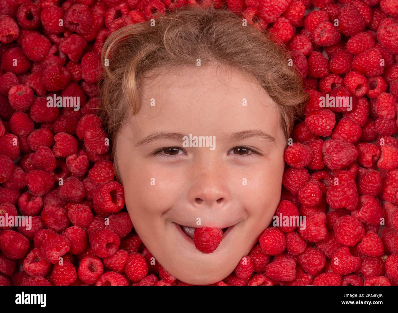 Child face with raspberry frame, close up raspberry background Stock ...