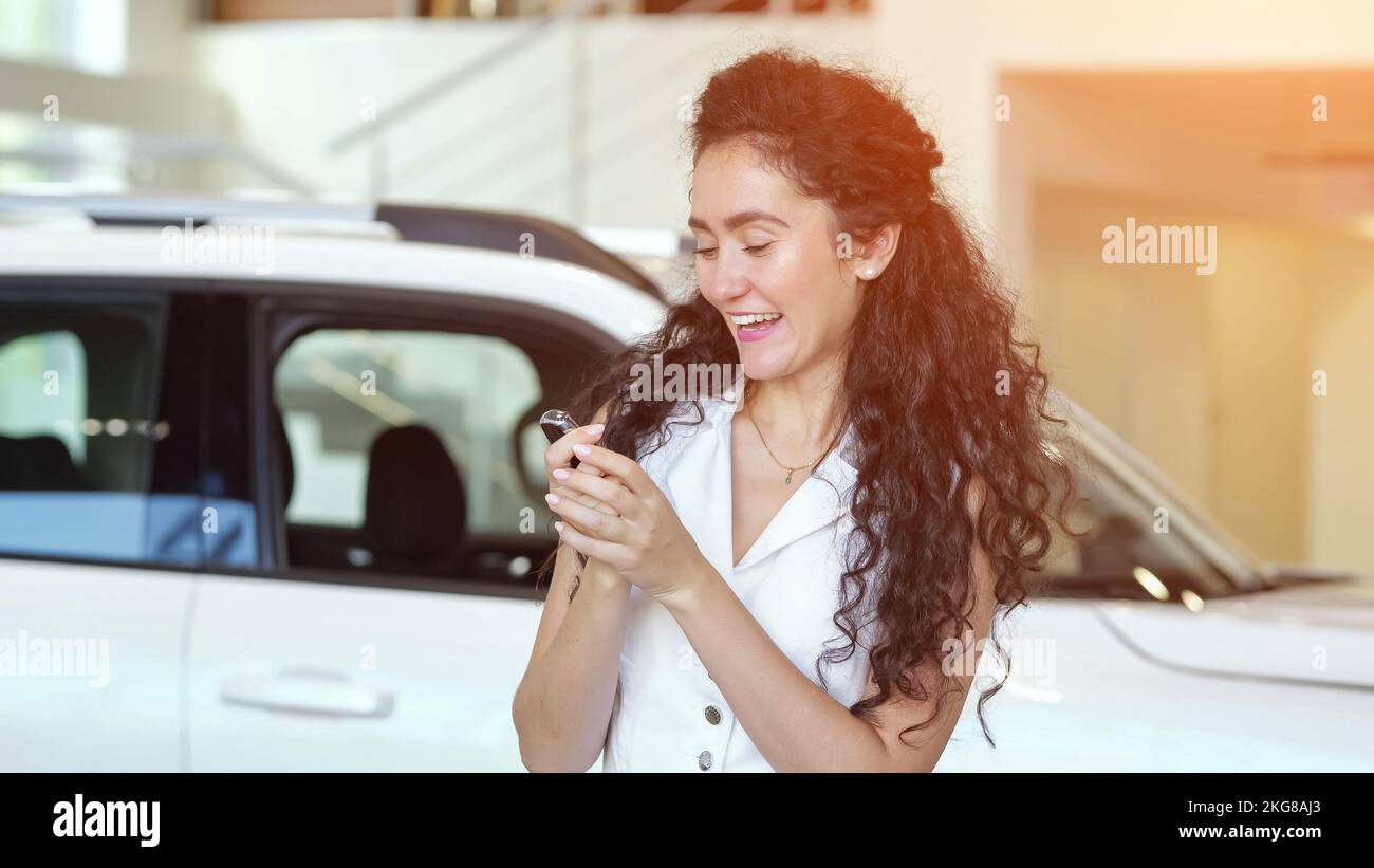 Woman shows car keys to won vehicle in automobile salon Stock Photo - Alamy