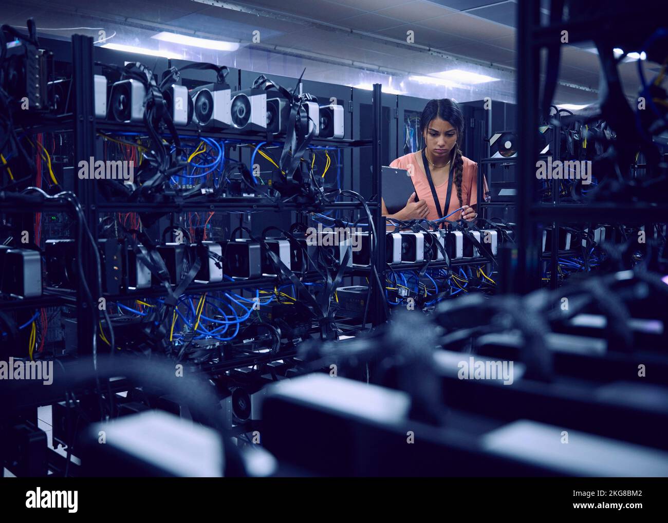 Female technician working in server room Stock Photo - Alamy