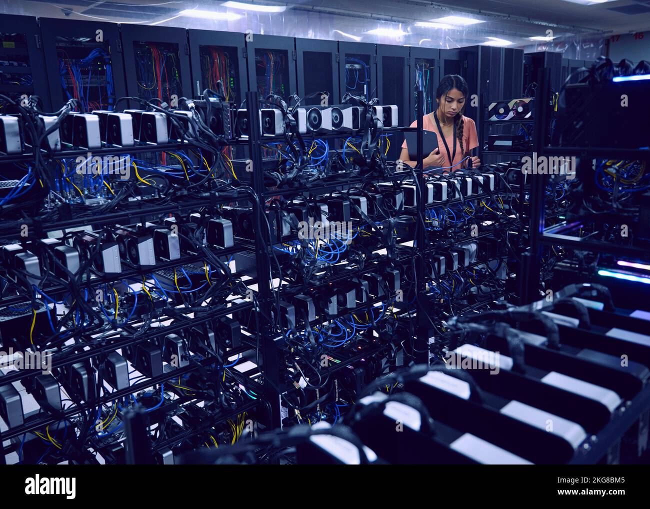 Female technician working in server room Stock Photo - Alamy