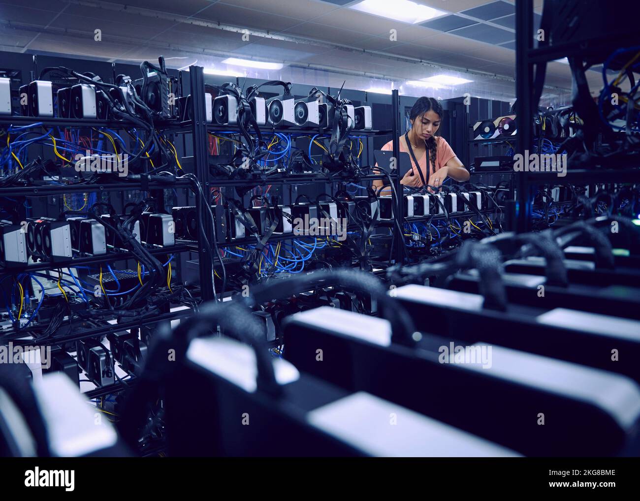 Female technician working in server room Stock Photo - Alamy