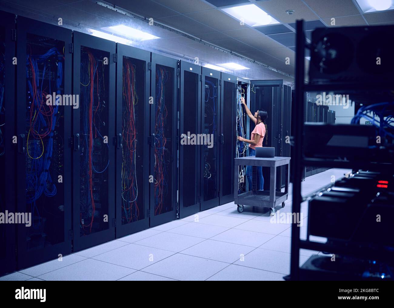 Female technician working in server room Stock Photo - Alamy