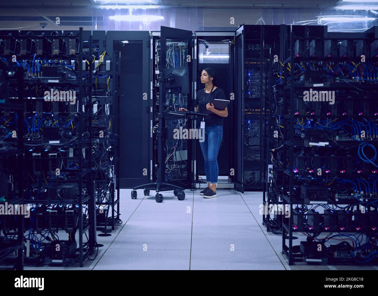 Female technician working in server room Stock Photo - Alamy
