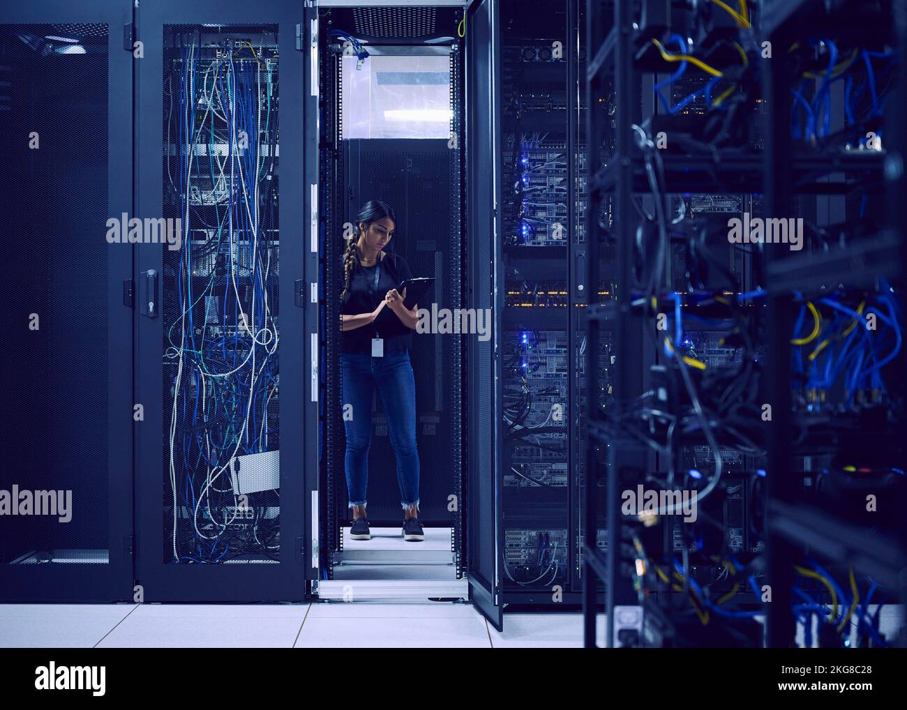 Female technician working in server room Stock Photo - Alamy