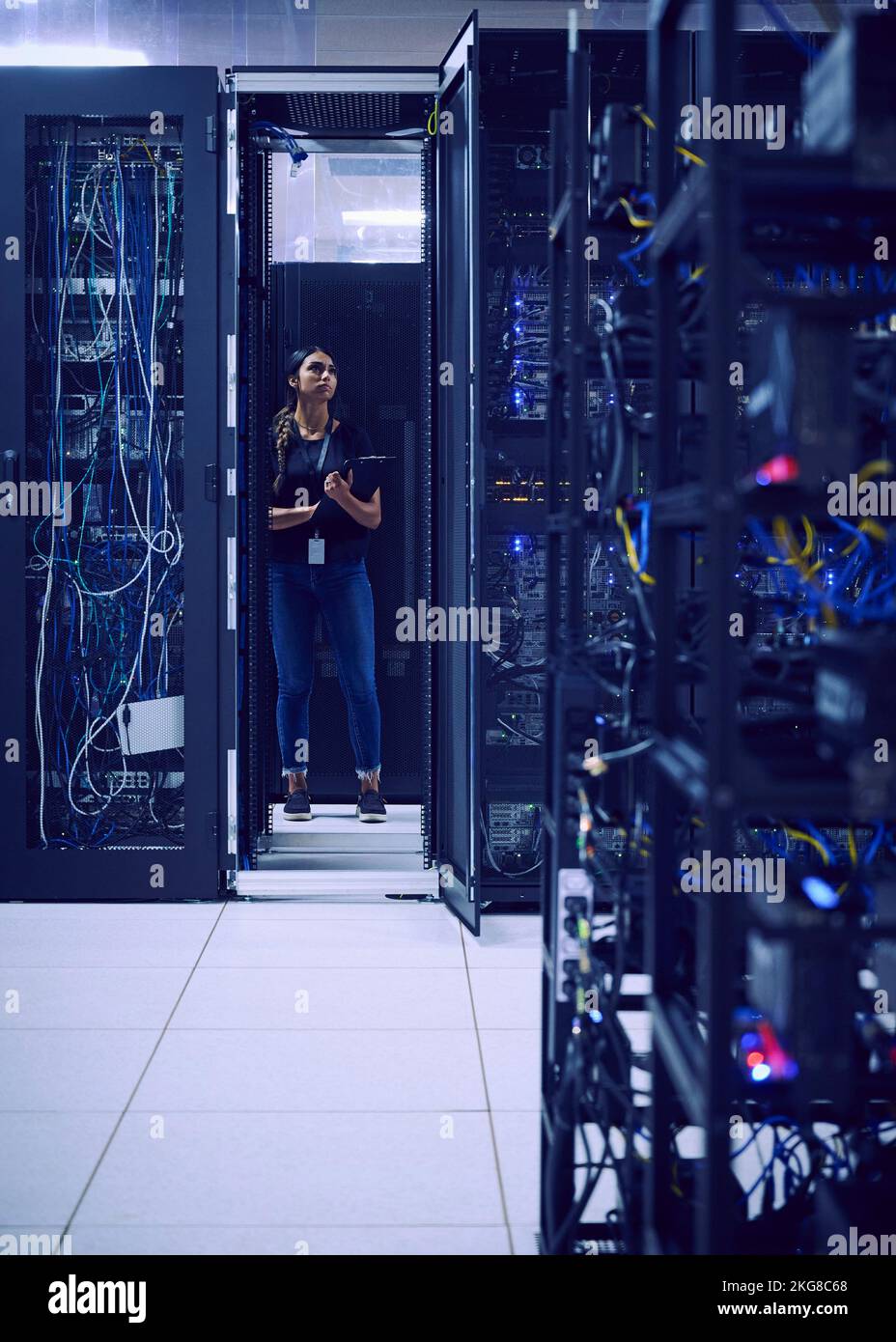 Female technician working in server room Stock Photo - Alamy