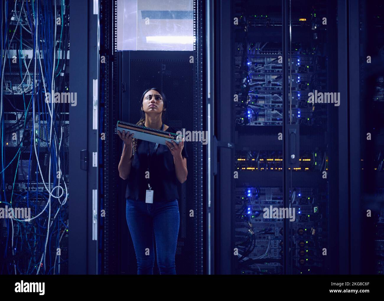 Female technician carrying hard drive in server room Stock Photo - Alamy
