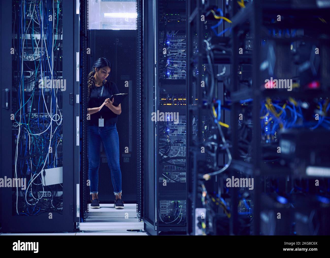 Female technician working in server room Stock Photo - Alamy