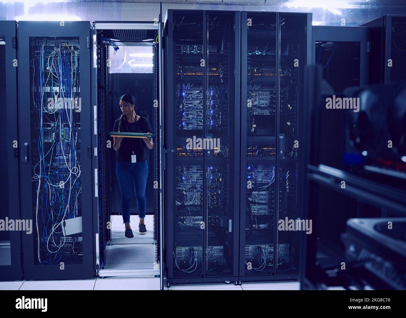 Female technician carrying hard drive in server room Stock Photo - Alamy
