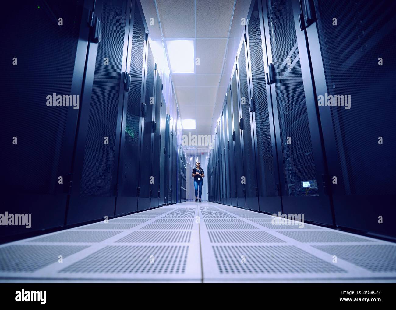 Female technician working in server room Stock Photo - Alamy