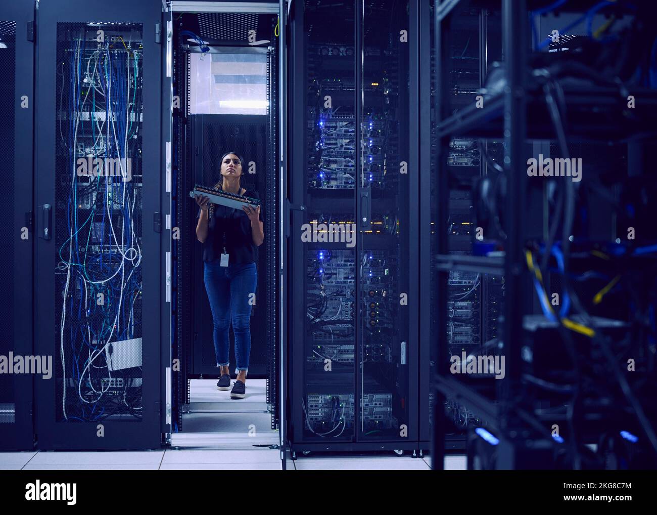 Female technician carrying hard drive in server room Stock Photo - Alamy