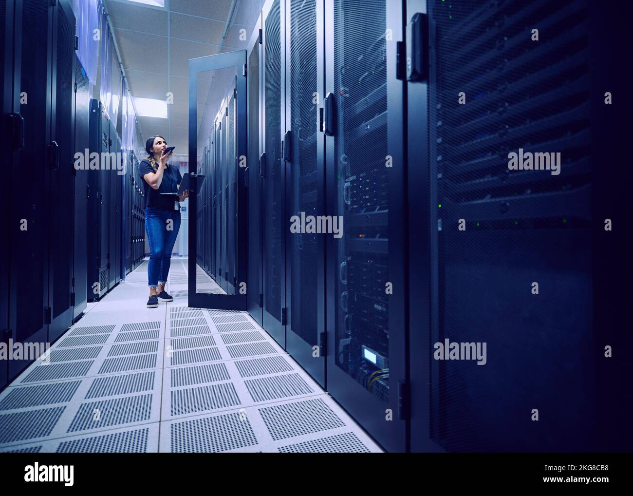 Female technician working in server room Stock Photo - Alamy