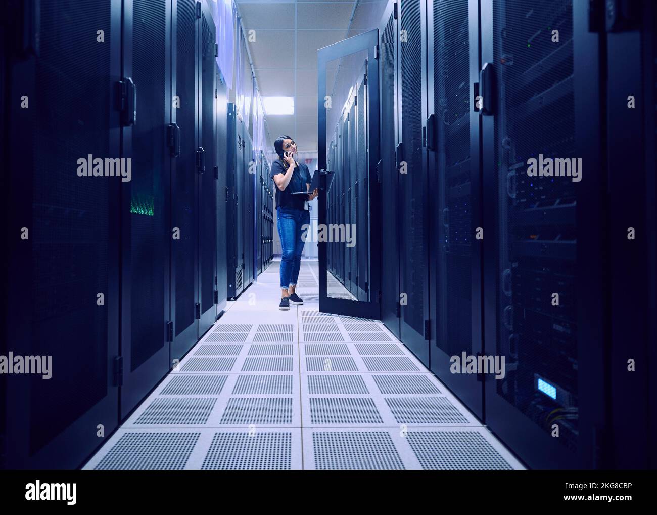 Female technician working in server room Stock Photo - Alamy