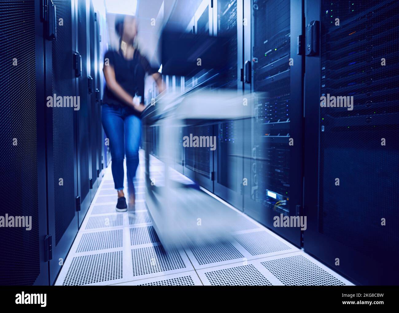 Female technician walking in server room, blurred in motion Stock Photo ...