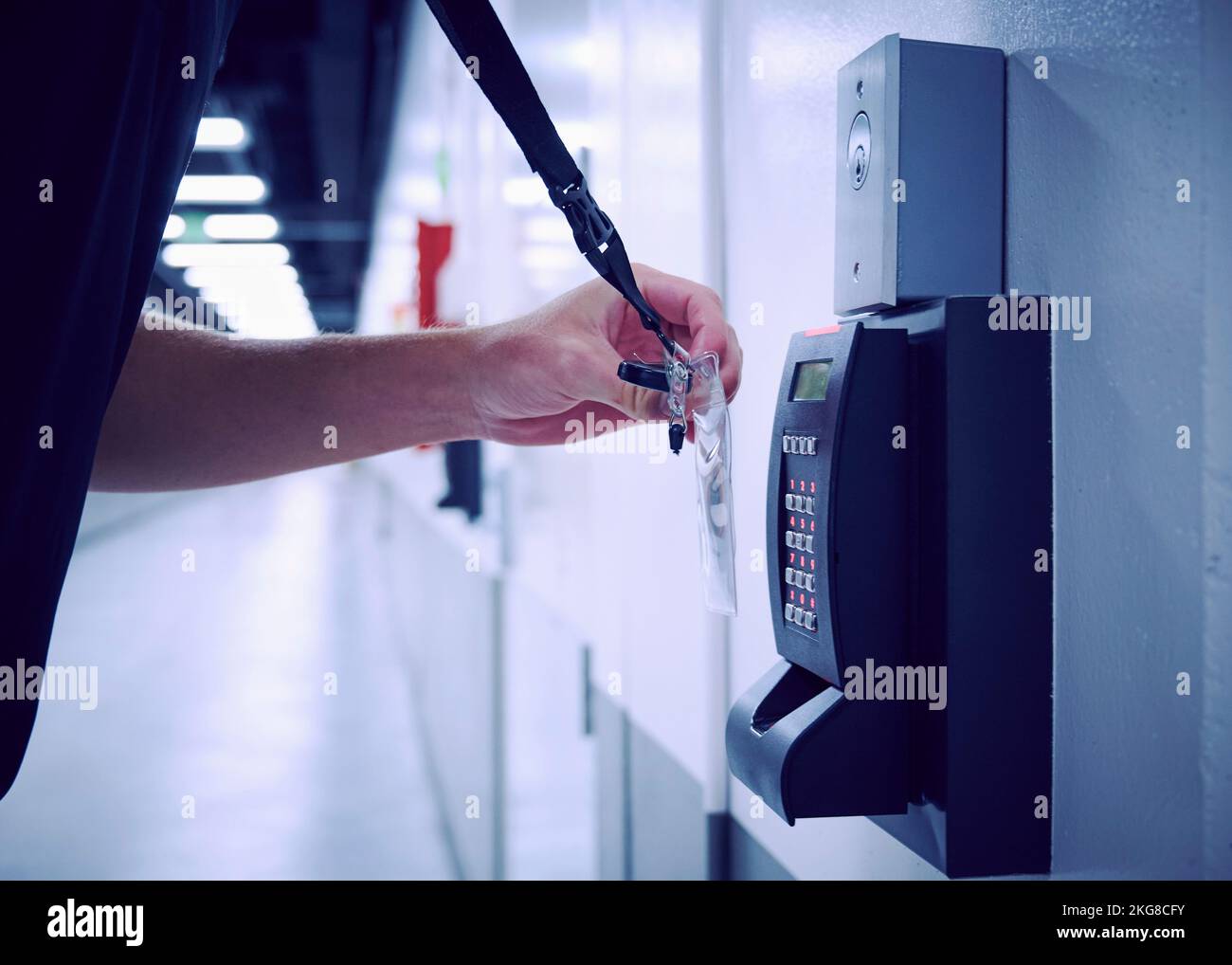 Close-up of employee using keycard and digital door lock in office ...