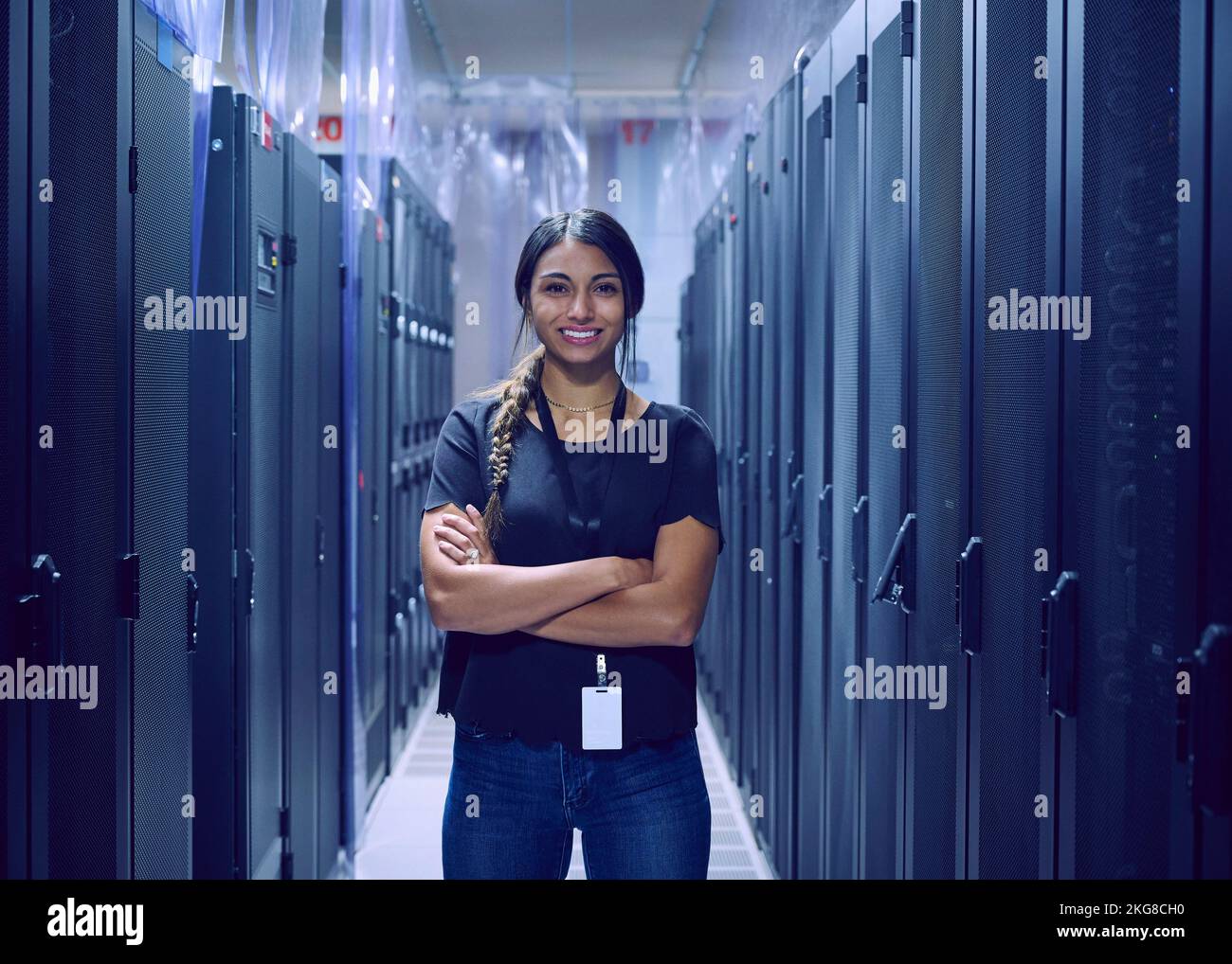 Portrait of smiling female technician standing in server room Stock ...