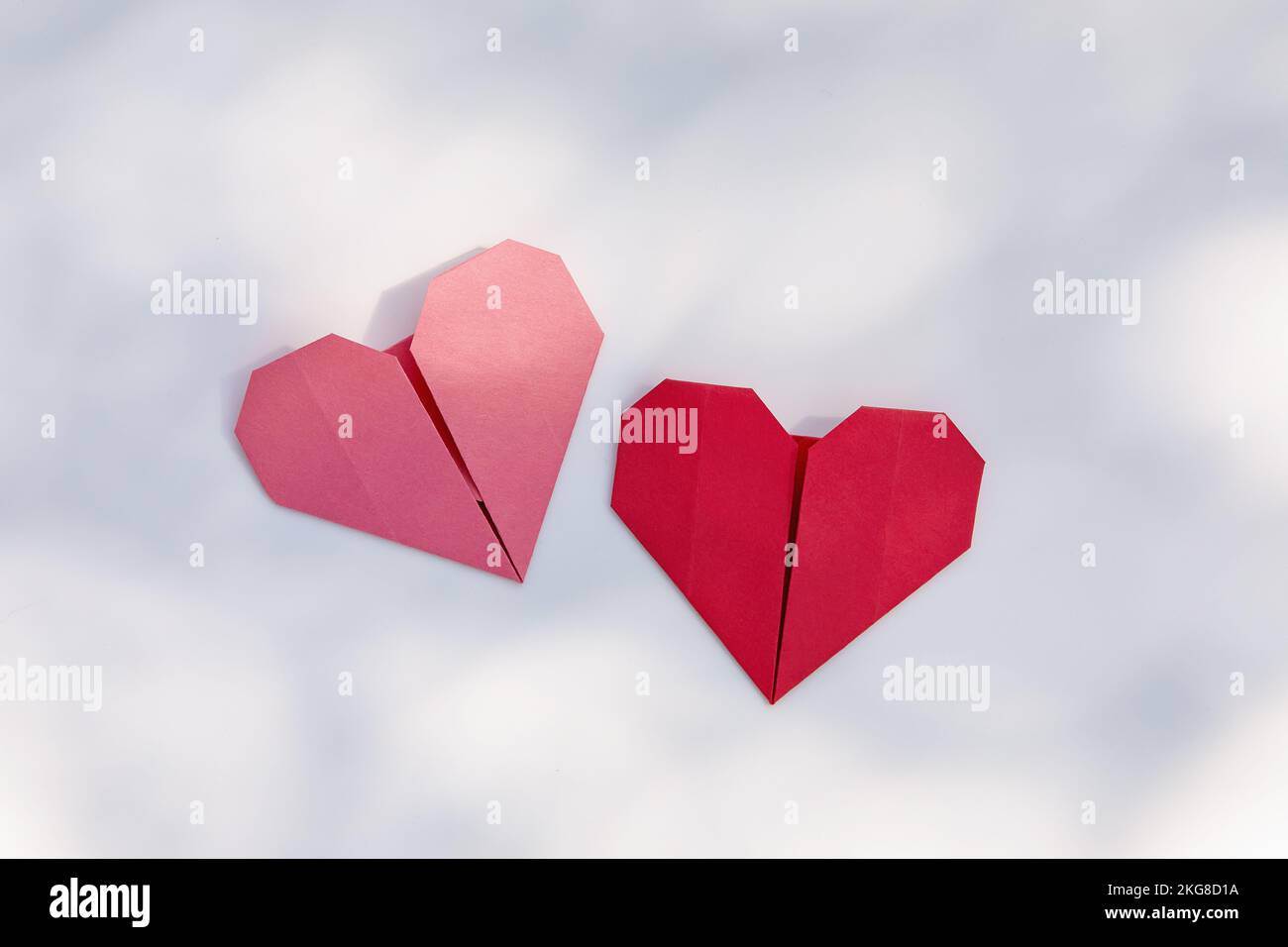 Red and pink origami hearts on white background Stock Photo - Alamy