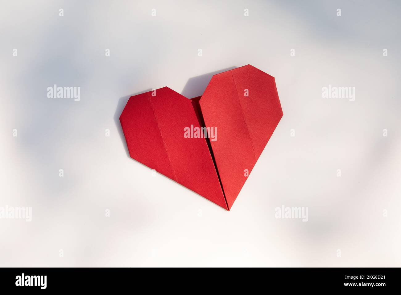 Red origami heart on white background Stock Photo - Alamy