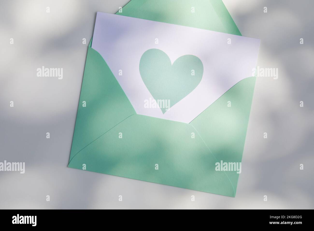 Green valentine card on white background Stock Photo - Alamy