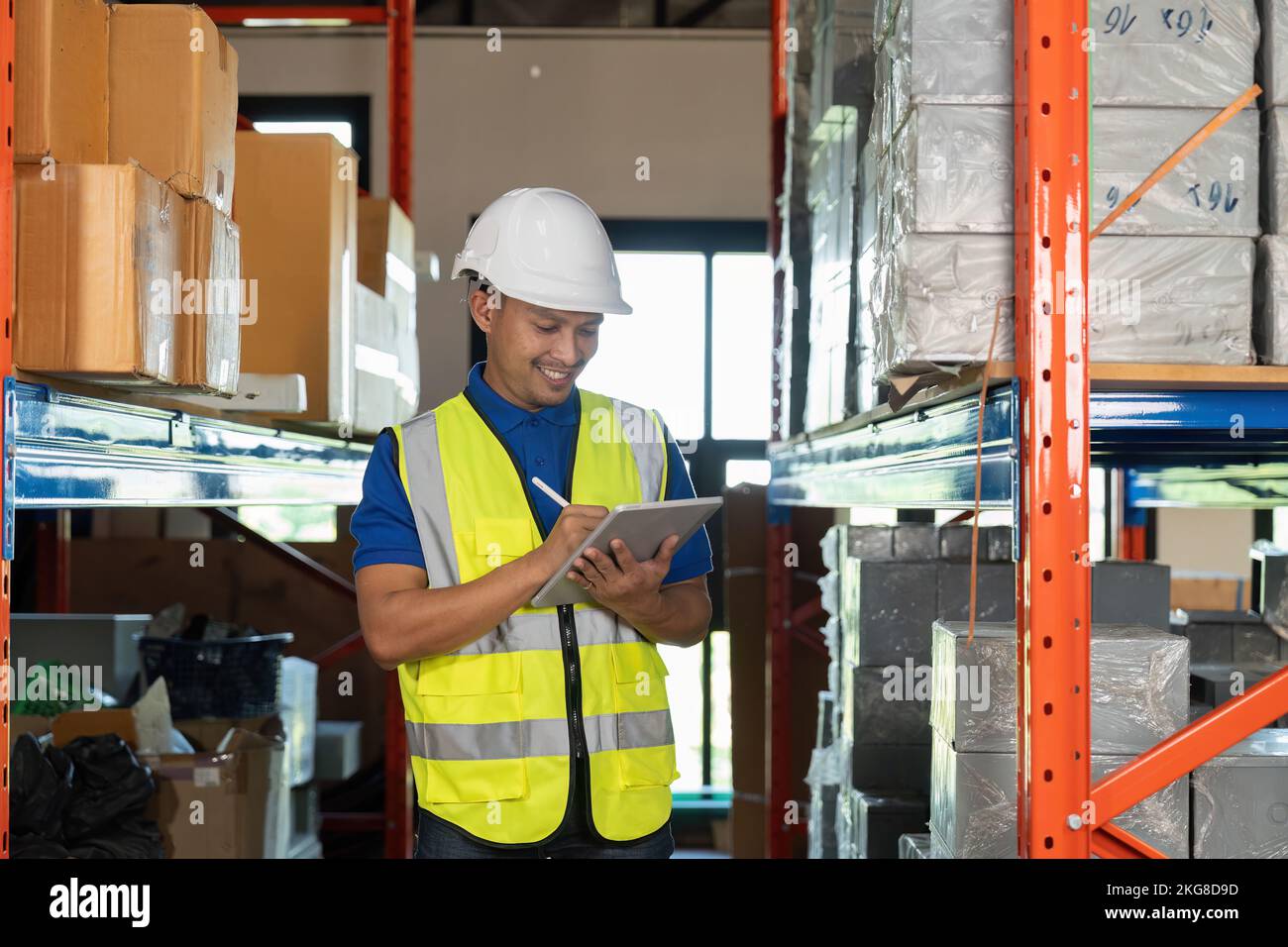 Asian warehouse worker checking the delivery status of the package with ...