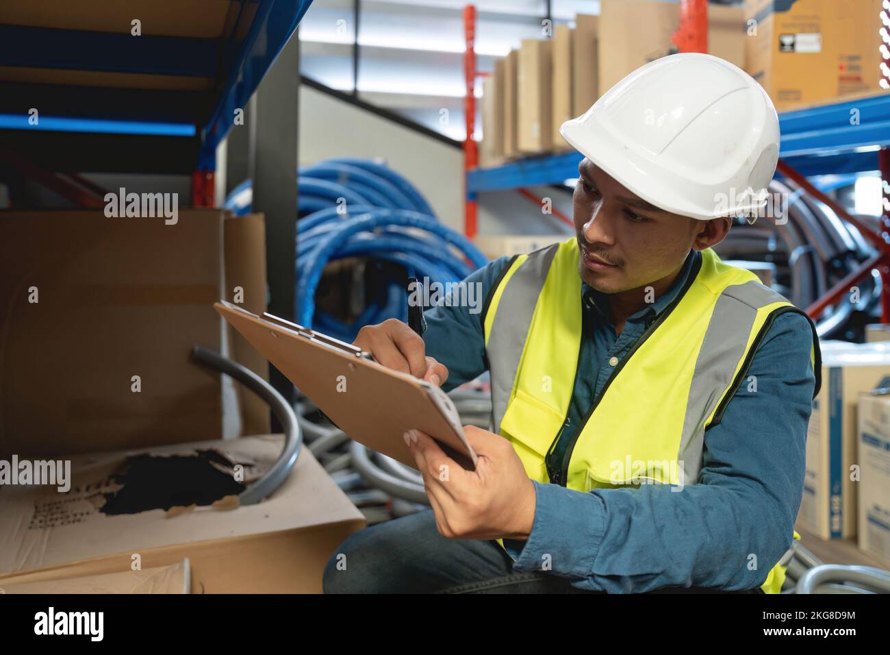 Asian man wearing reflective jacket holding checklist paper standing in ...