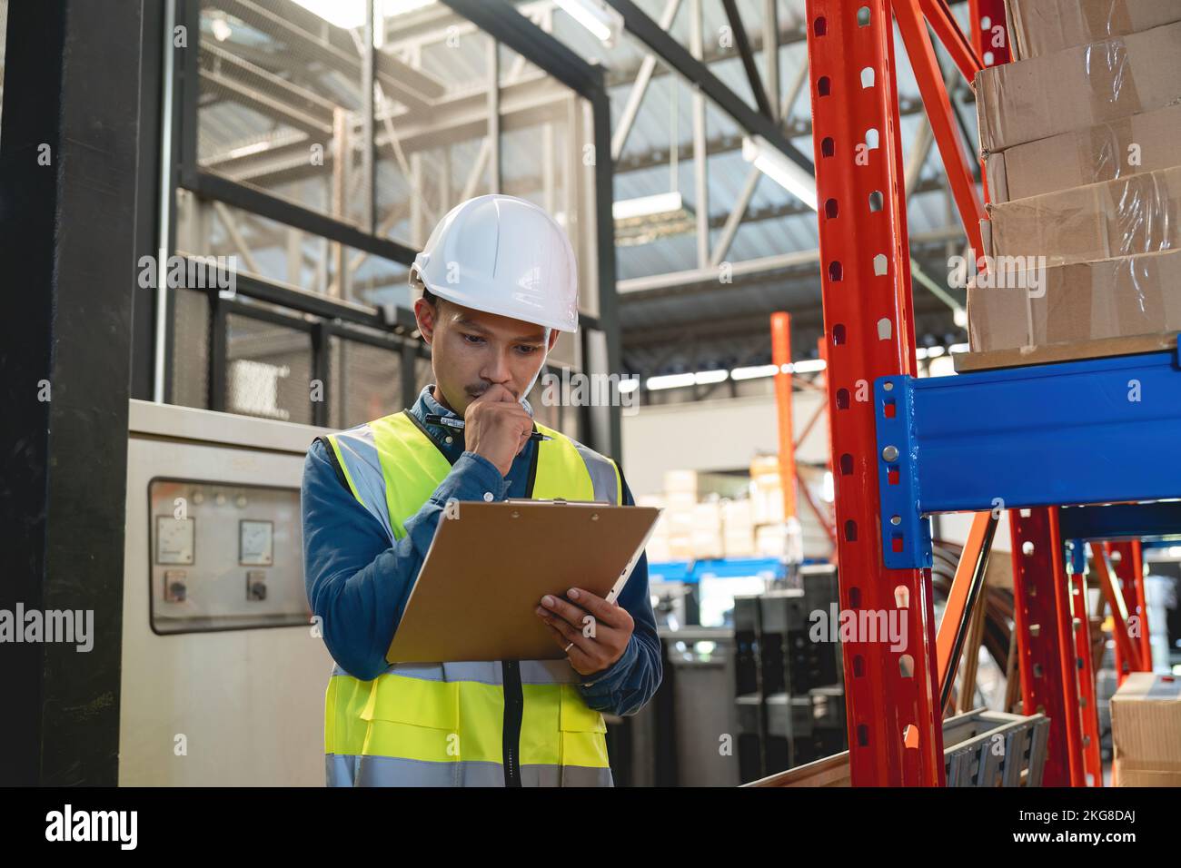 Asian man wearing reflective jacket holding checklist paper standing in ...