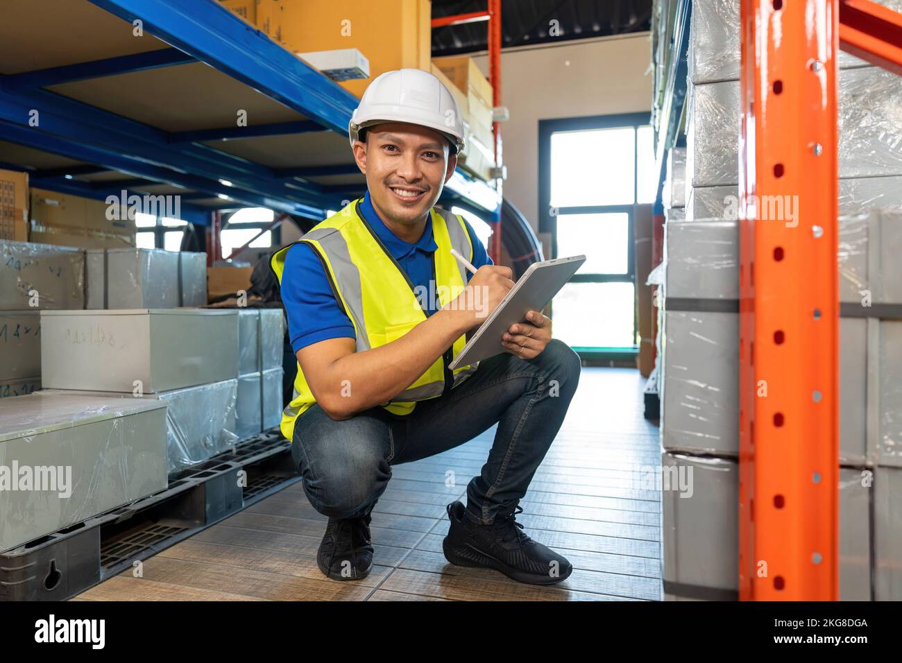 Portrait asian warehouse worker checking the delivery status of the ...