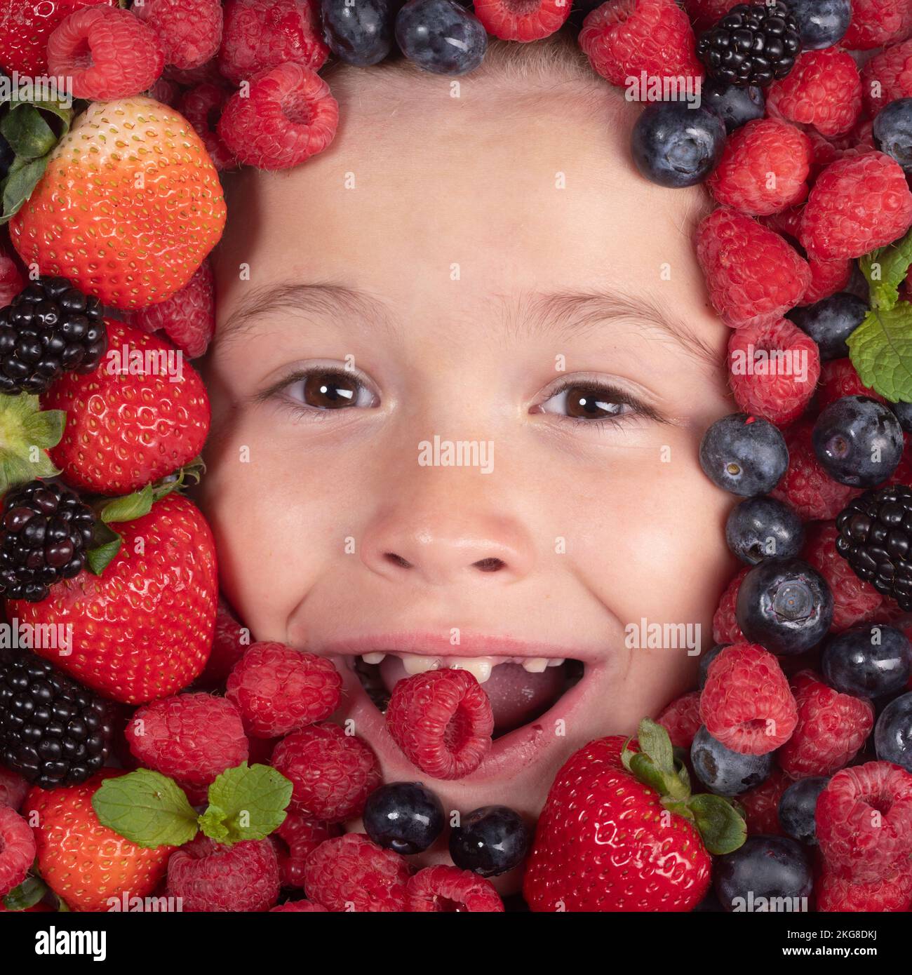 Healthy vitamins fruits. Kids face with berries mix of strawberry ...