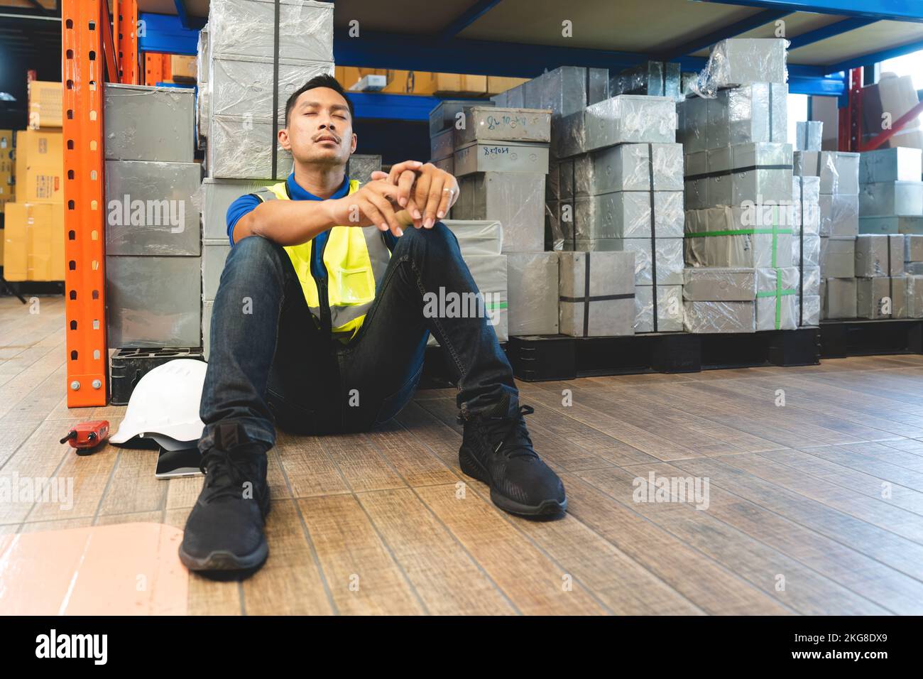 Asian male warehouse staff worker manage factory products goods and ...
