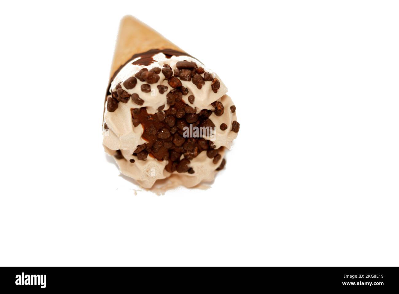 Ice cream vanilla cone with topping of chocolate chips pieces in a ...