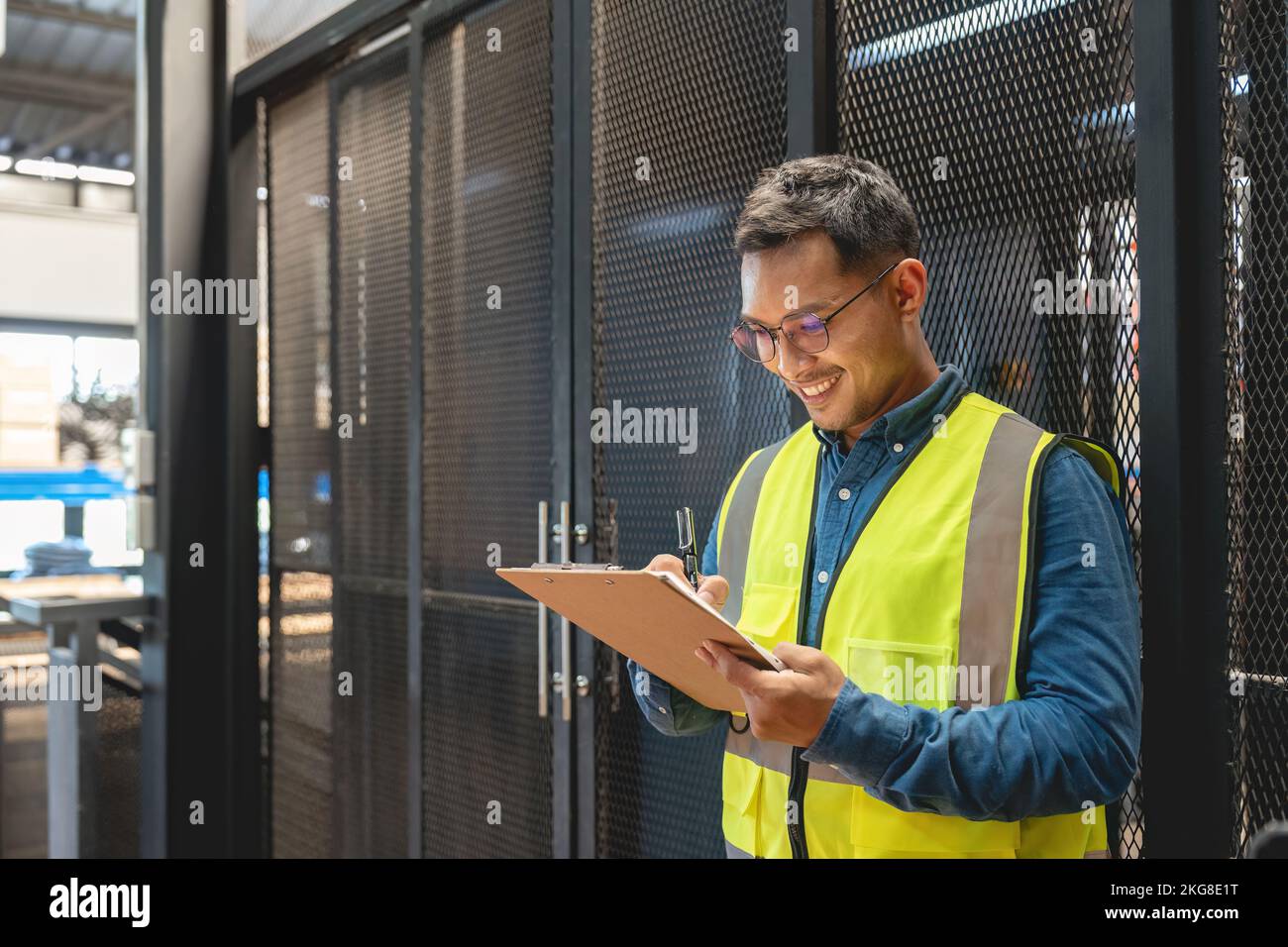 Happy asian male engineer worker enjoy working in factory industry ...