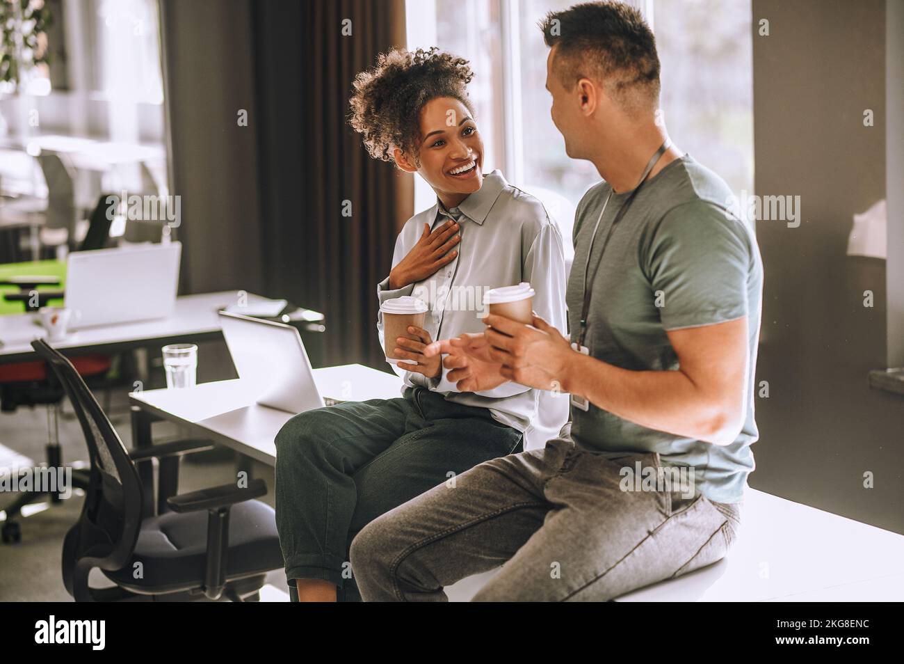 Office worker communicating with her colleague during the coffee break ...